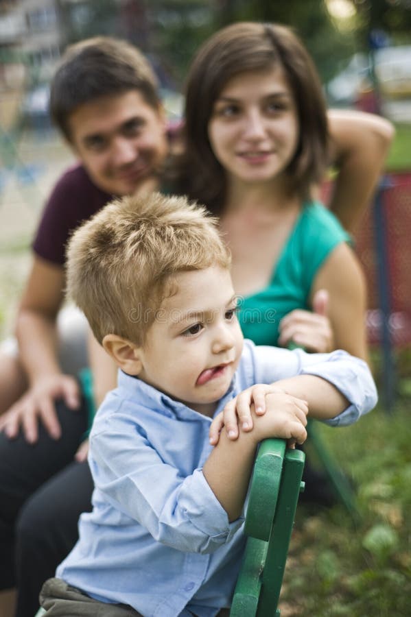 Happy parents and kid stock image. Image of holding, people - 16033317