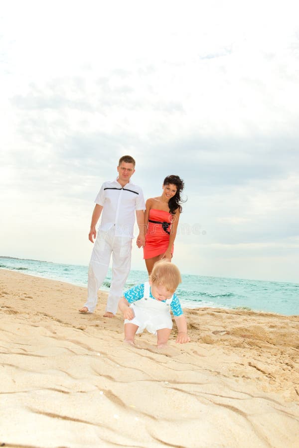 Happy parents look at son stock photo. Image of girl - 13815058