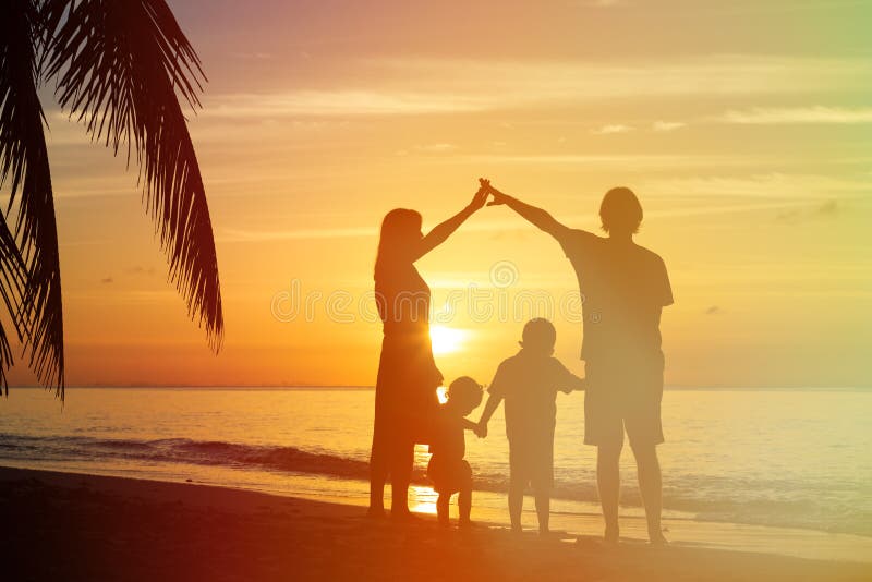 Happy Parents Making Home for Kids at Sunset Beach Stock Photo - Image ...