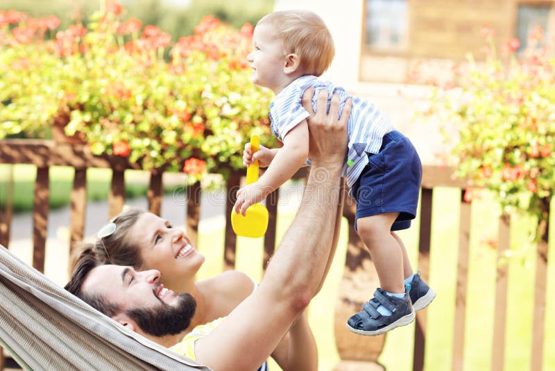 Happy Parents Playing with Their Baby Boy in Hammock Stock Photo ...