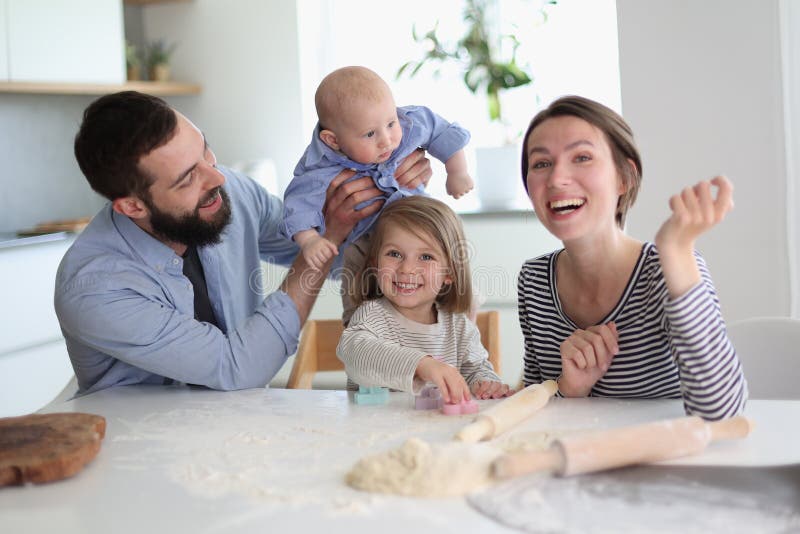 Young Parents Playing with Children in the Kitchen Stock Photo - Image ...