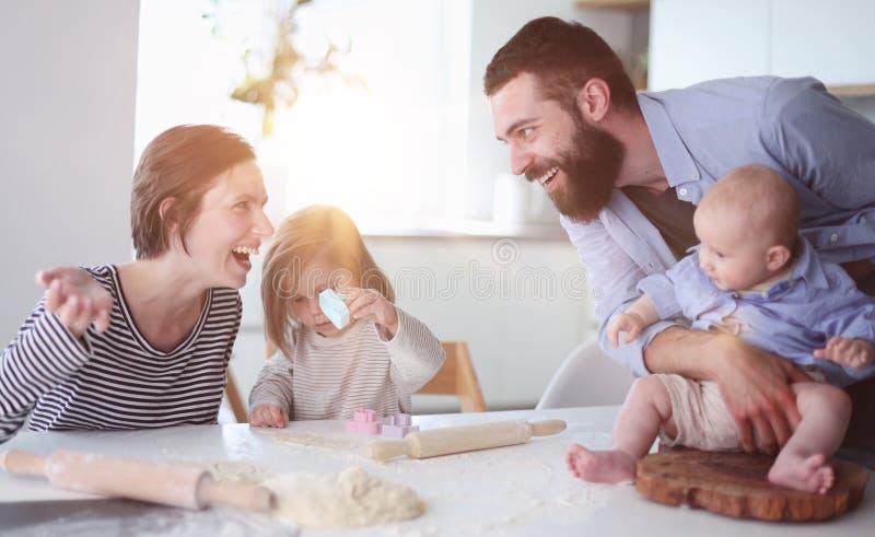 Young Parents Playing with Children in the Kitchen Stock Photo - Image ...