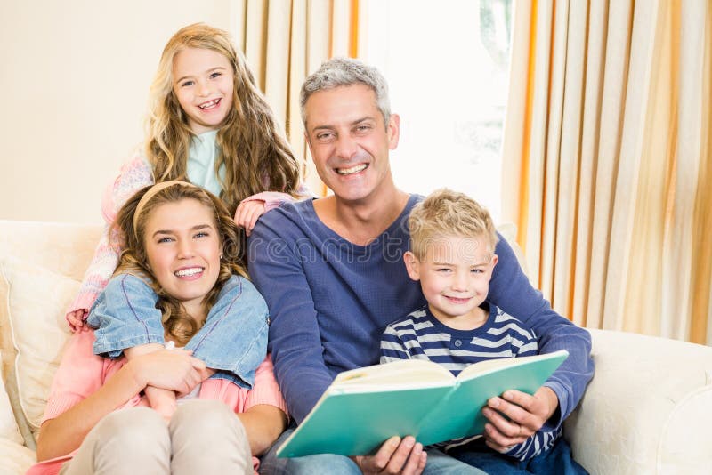 Happy Parents Reading To Their Kids Stock Photo - Image of domestic ...