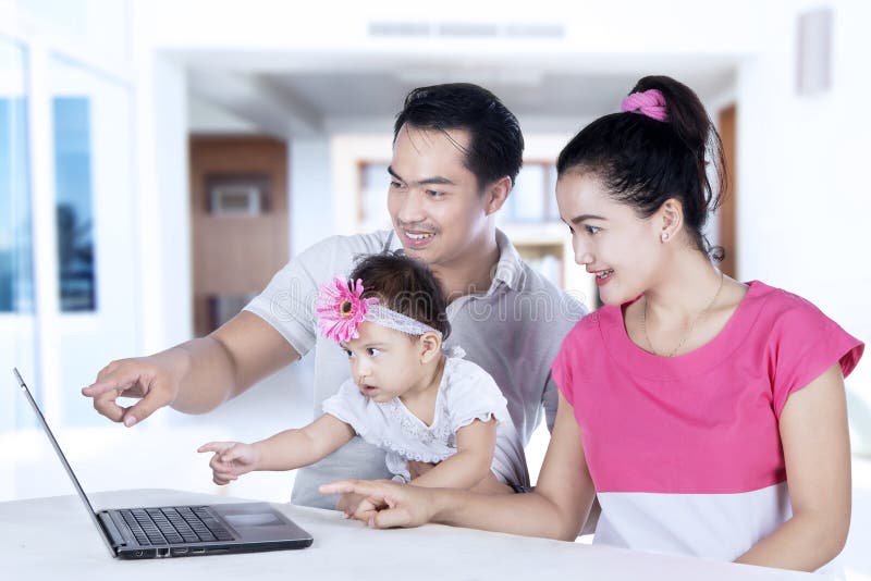 Happy Parents Teaching Daughter with Laptop Stock Image - Image of ...
