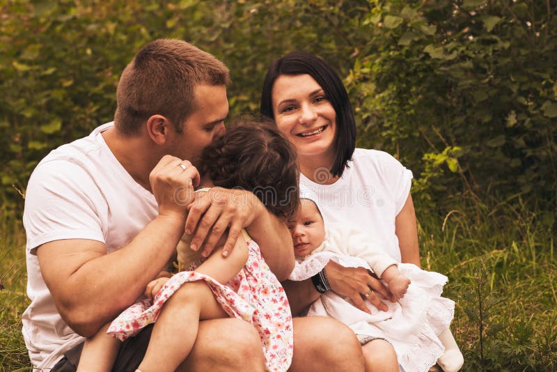 Happy Parents and Two Children Together, Outdoors Stock Photo - Image ...