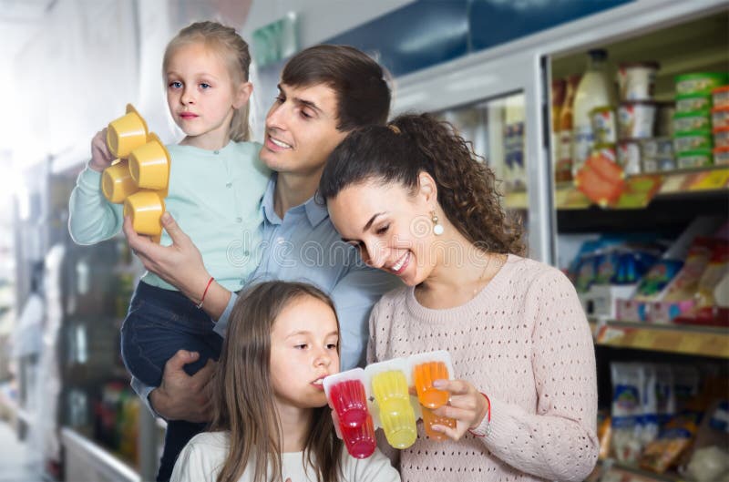 Happy Parents with Two Kids Holding Purchases in Store Stock Photo ...