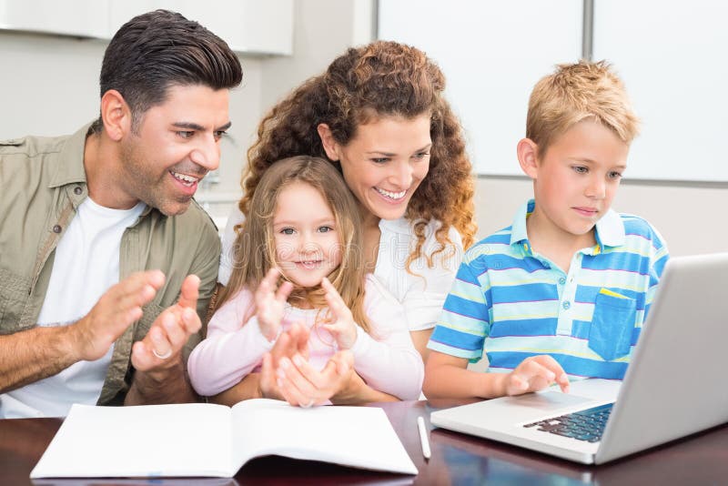 Happy Parents Using Laptop with Their Young Children Stock Image ...