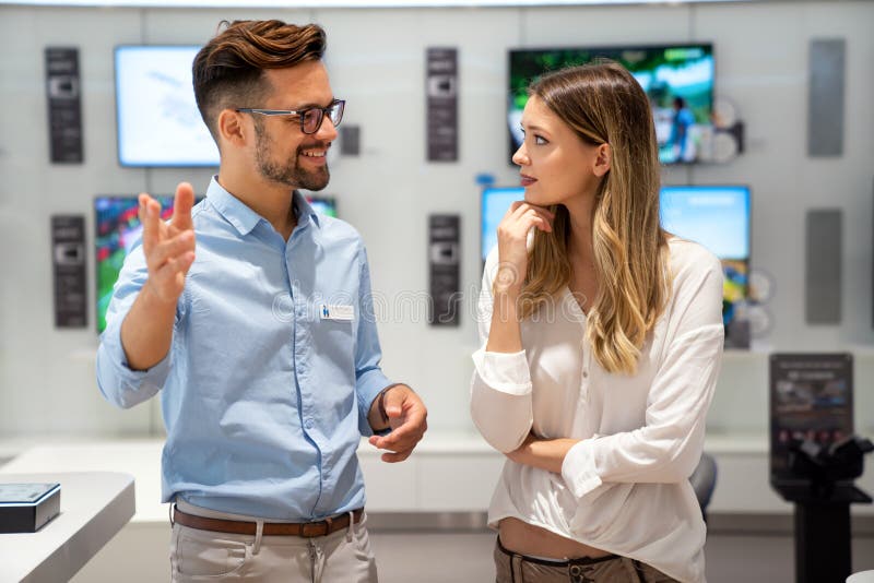 Happy People in Consumer Electronics Retail Store Looking at New ...