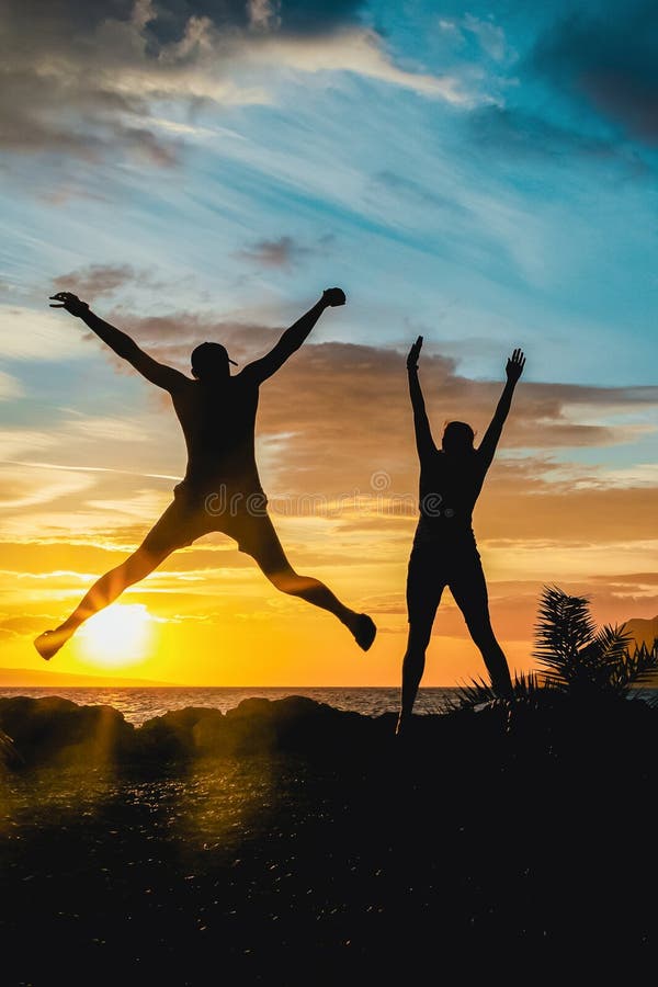 Happy People Jumping Over Sunset, Concept Having Fun, Freedom and Joy ...