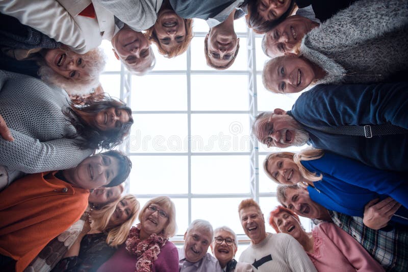 Happy People Looking Down at Camera Stock Image - Image of huddle ...