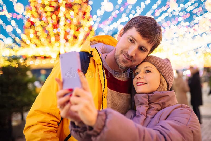 Happy People Take A Selfie Together On A City Street On Christmas Night