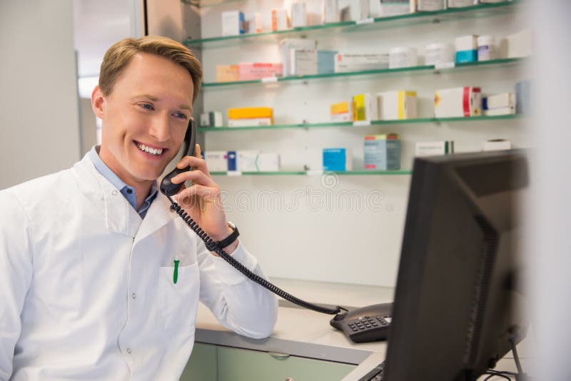 Happy Pharmacist on the Phone Using Computer Stock Photo - Image of ...