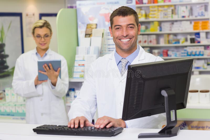 Happy Pharmacist Using Computer Stock Image - Image of indoors, male ...