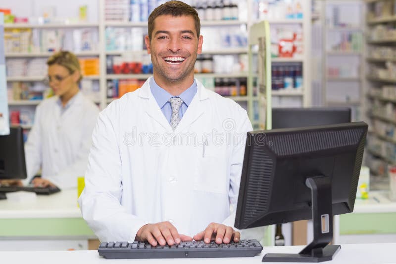 Happy Pharmacist Using Computer Stock Photo - Image of keyboard, people ...
