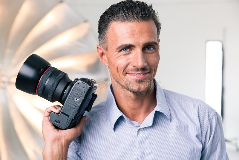 Happy Photographer Holding Camera Stock Image - Image of flash, indoors ...