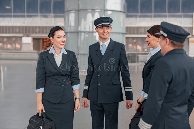 Happy Pilots and Stewardesses Communicating in the Airport Terminal ...