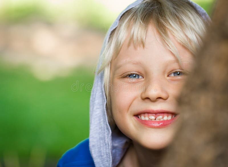 Happy Playing Child Peeking from Behind a Tree Stock Photo - Image of ...