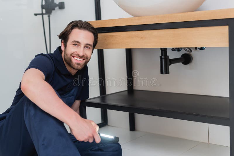 Happy Plumber with Flashlight Looking at Stock Image - Image of ...