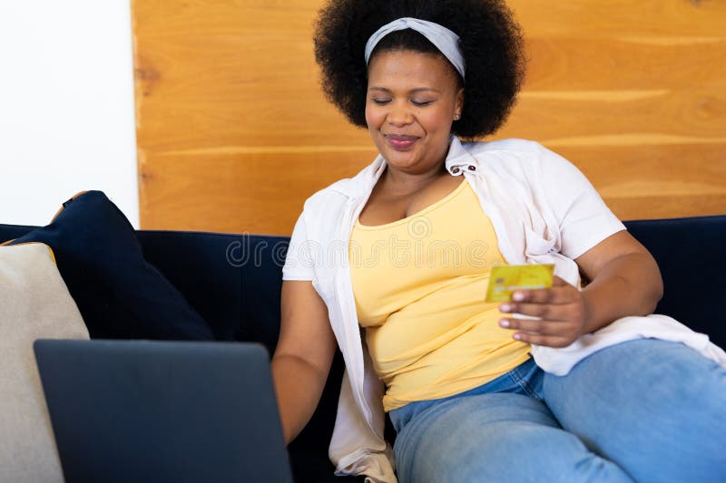 Happy Plus Size African American Woman On Sofa Online Shopping With