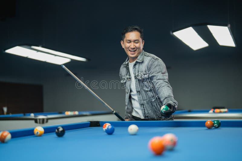 Happy Pool Player Smiling while Grabbing the Billiard Ball Stock Image ...