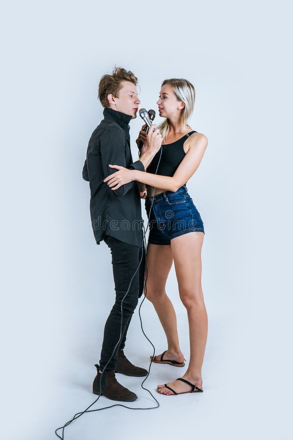 Happy Portrait of Couple Holding Microphone and Sing a Song Stock Image ...