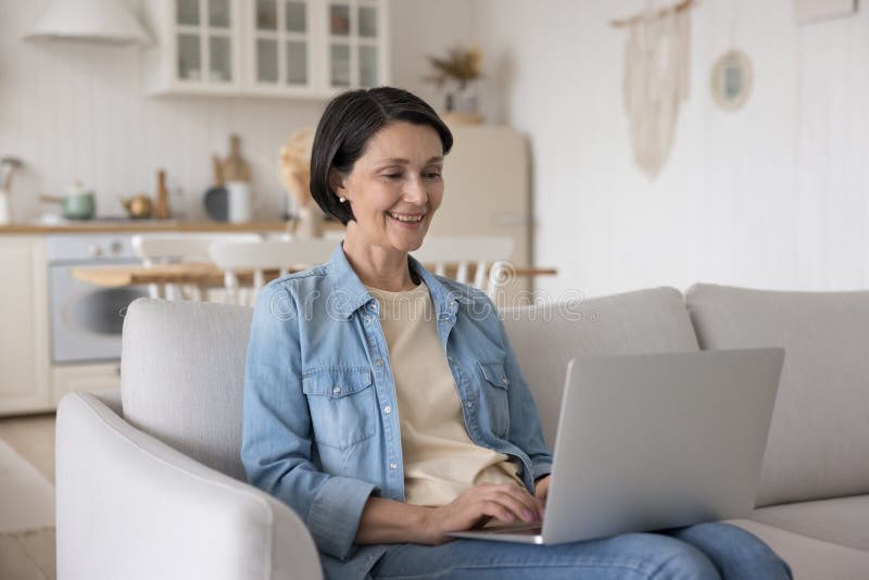 Happy Positive Mature Lady Using Computer for Internet Communication ...