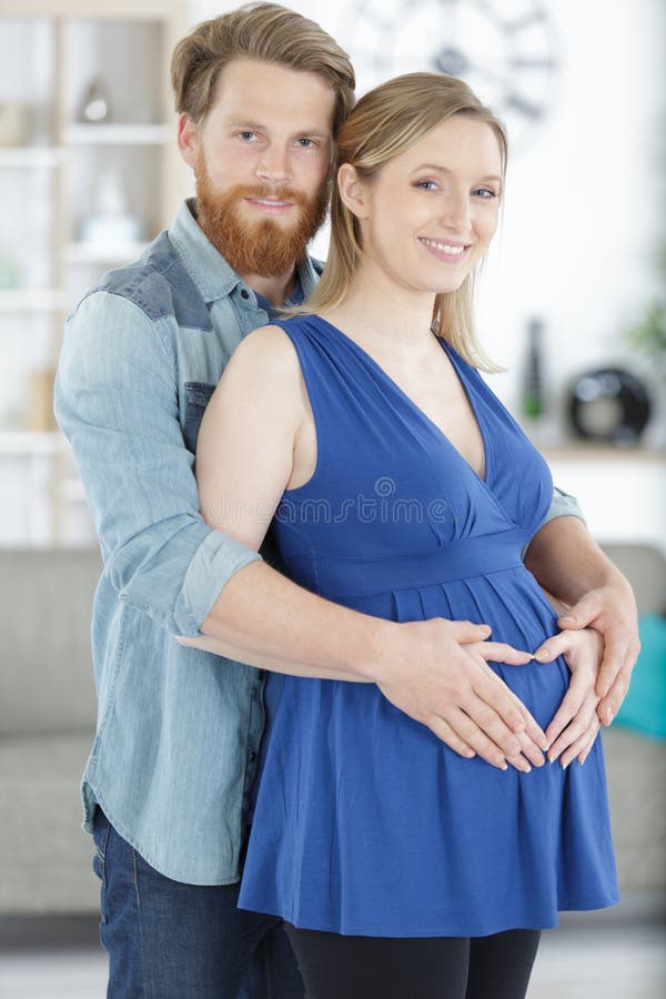Happy Pregnant Couple Hugging Stock Photo - Image of expecting, home ...