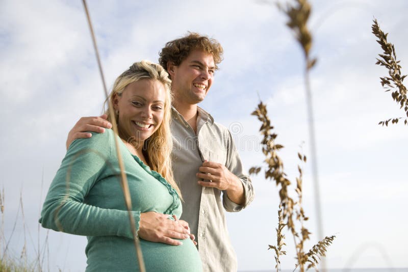 Happy Pregnant Couple Standing Together at Beach Stock Image - Image of ...