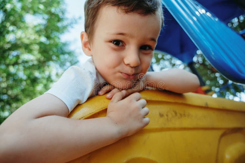 Happy Preschooler Boy Playing on Slide on Playground in Summer Stock ...