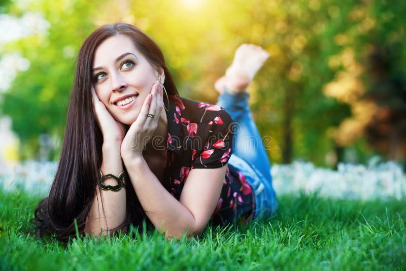Happy Pretty Girl Laying on the Grass Stock Photo - Image of brunette ...