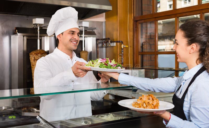 Happy Professional Chef and Young Waitress Taking Kebab for Cli Stock ...