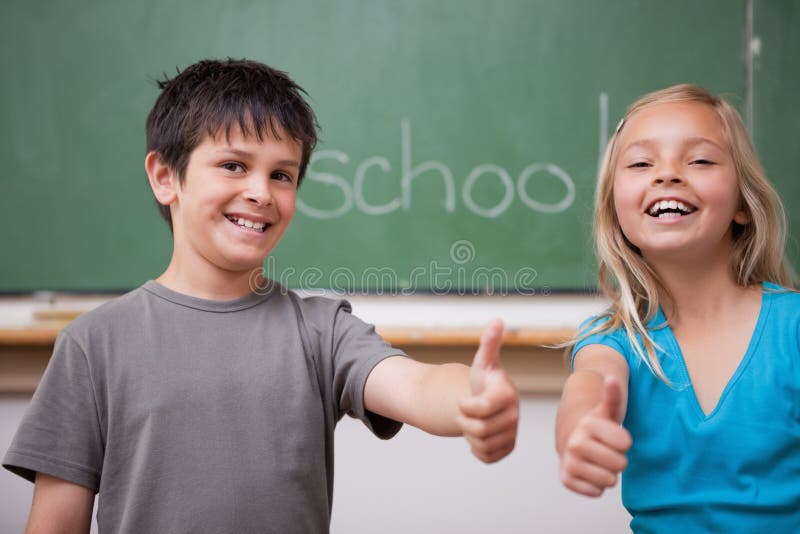 Happy Pupils Posing with the Thumb Up Stock Photo - Image of blackboard ...