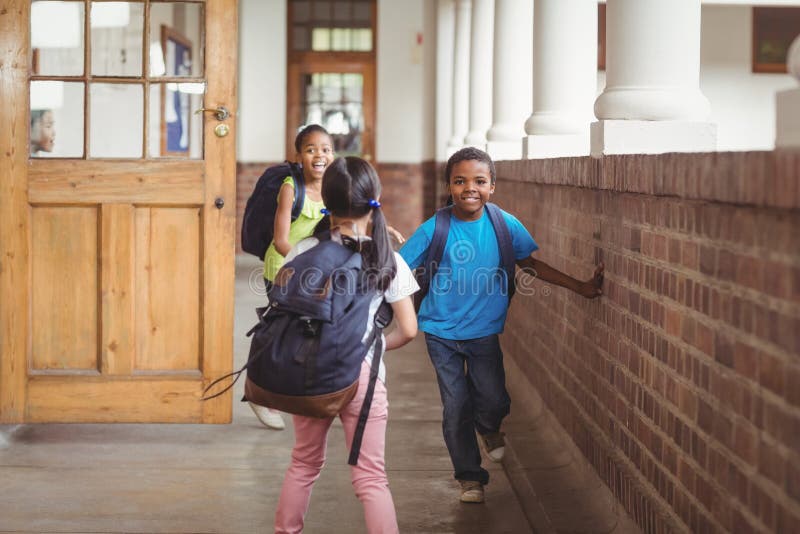 Happy Pupils Running Around the Corridor Stock Photo - Image of female ...