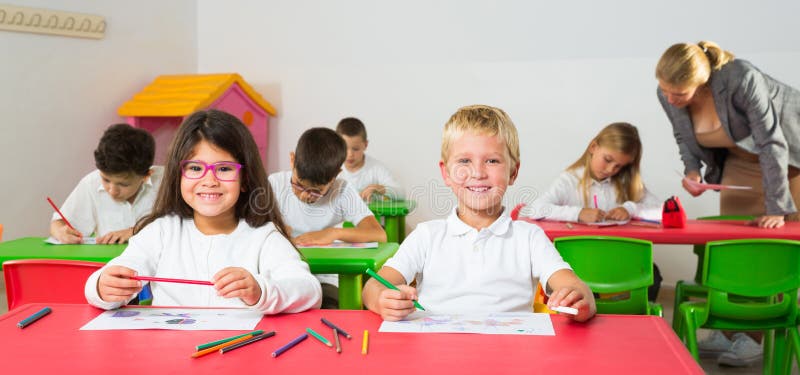 Happy Pupils Working in Classroom Stock Image - Image of explaining ... Happy Pupils Working in Classroom Stock Image - Image of explaining ...