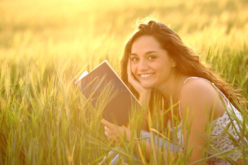 Happy Reader Holding Book Looks at Camera Stock Photo - Image of ...