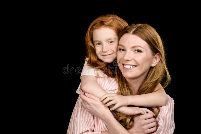 Happy Redhead Mother And Daughter Embracing Isolated On Black Stock
