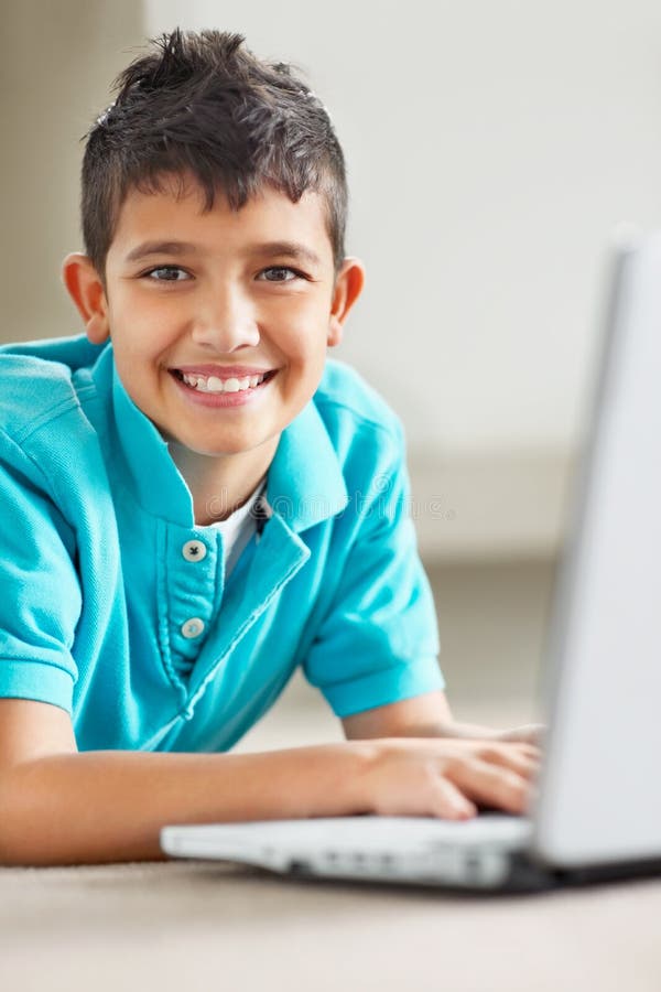 Happy Relaxed Boy Using a Laptop on Floor Stock Photo - Image of little ...