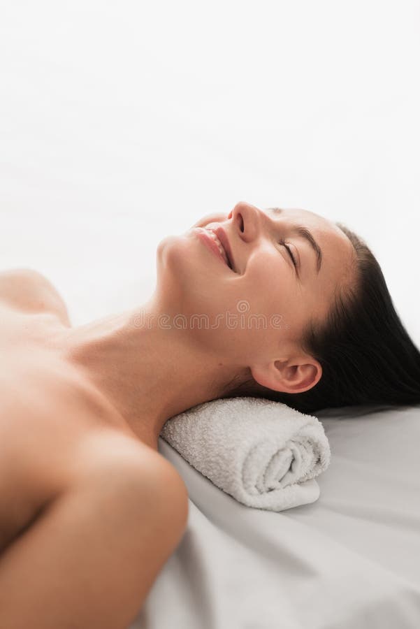 Happy Relaxed Woman Lying On Massage Table With Closed Eyes Stock Image