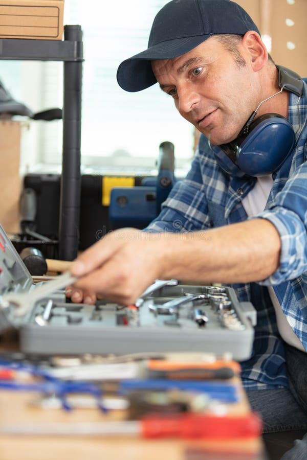 Happy Repairmanlooking for Tools in Toolbox Stock Image - Image of ...