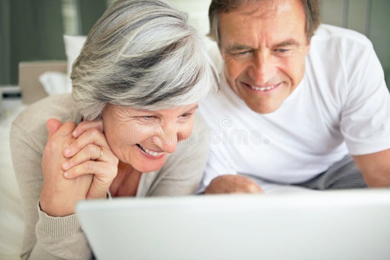 Happy Retired Couple Using a Laptop Together Stock Image - Image of ...