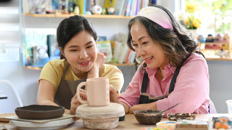 Happy Retired Woman and Young Woman Creating Handmade Ceramic Bowl in ...