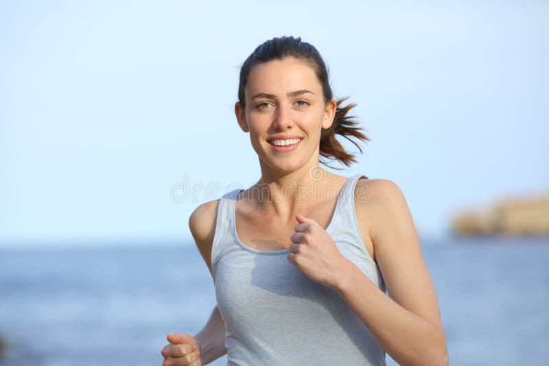 Happy Runner Running Towards Camera on the Beach Stock Image - Image of ...
