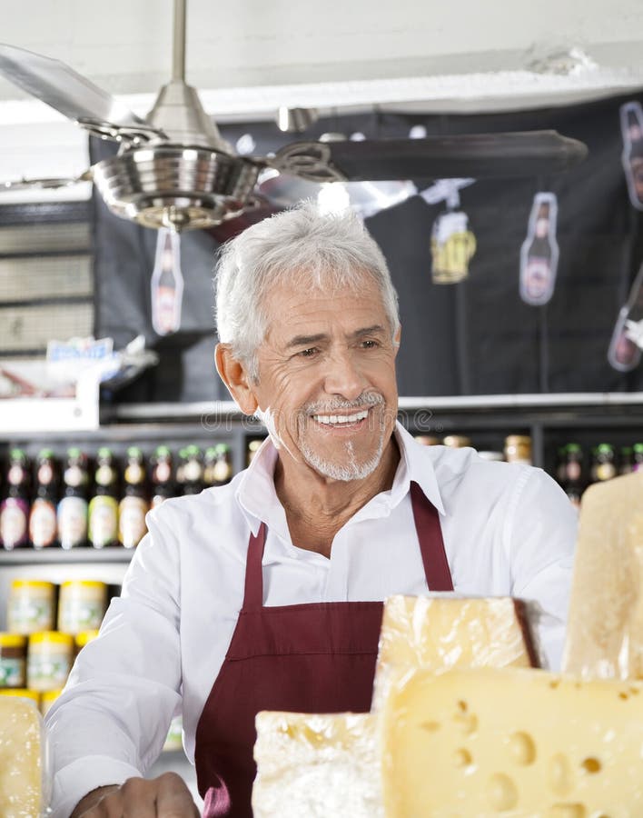 Happy Salesman Wrapping Cheese at Counter in Shop Stock Image - Image ...