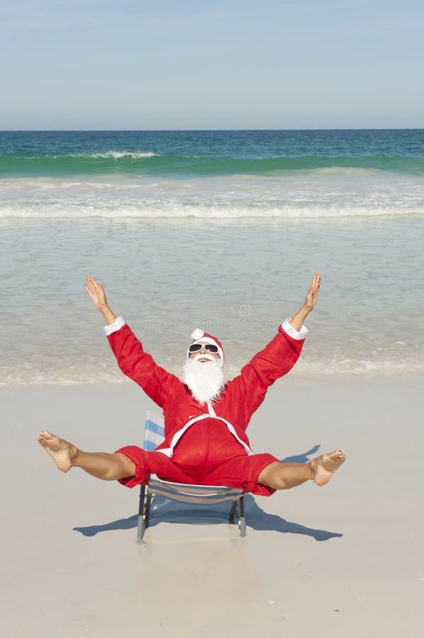 Santa Claus Sitting Under Parasol with Gifts on Beach Stock Photo ...