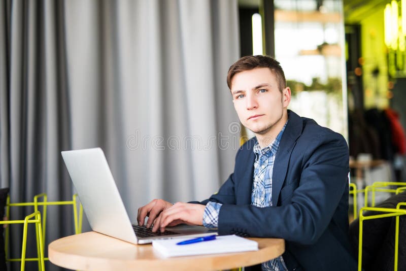 Happy Satisfied Young Man Working on Laptop and Looking at Camera in ...