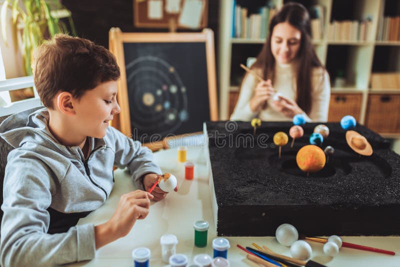 School Boy and Girl Making a Solar System for a School Science Project ...