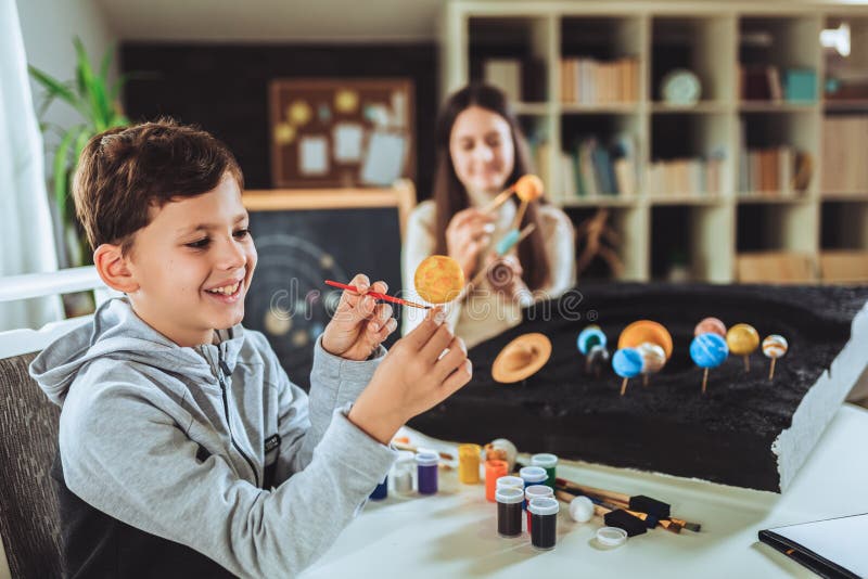 School Boy and Girl Making a Solar System for a School Science Project ...