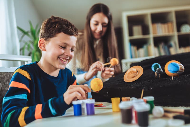 School Boy and Girl Making a Solar System for a School Science Project ...