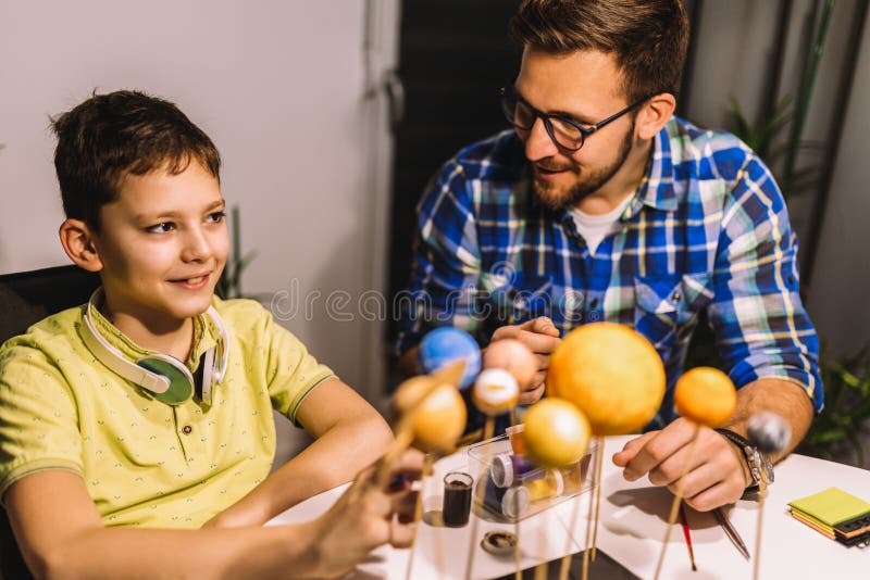 School Boy and His Father Making a Solar System for a School Science ...