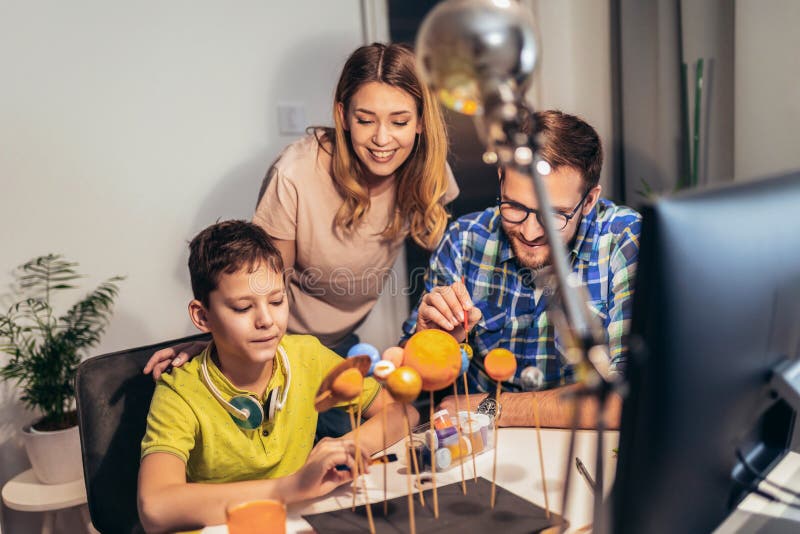 School Boy and His Parent Making a Solar System for a School Science ...